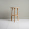 Fancy round oiled oak spindle side table by NiX
